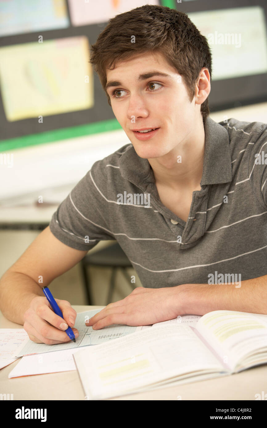 Male Teenage Student Studying In Classroom Stock Photo - Alamy