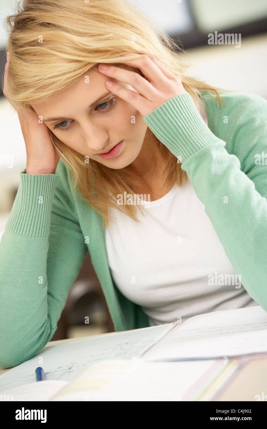 Stressed Female Teenage Student Studying In Classroom Stock Photo - Alamy
