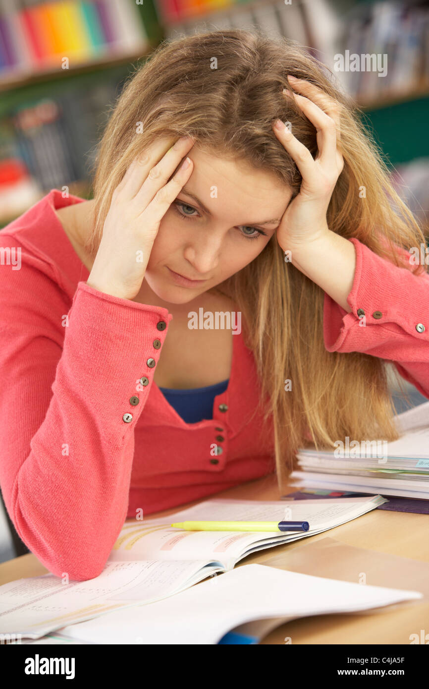 Stressed Female Teenage Student Studying In Classroom Stock Photo - Alamy