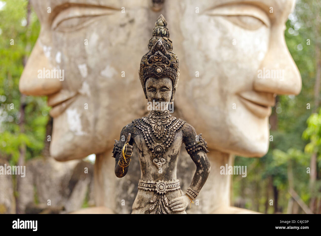 buddhist statue standing over double headed buddha face, nong khai ...