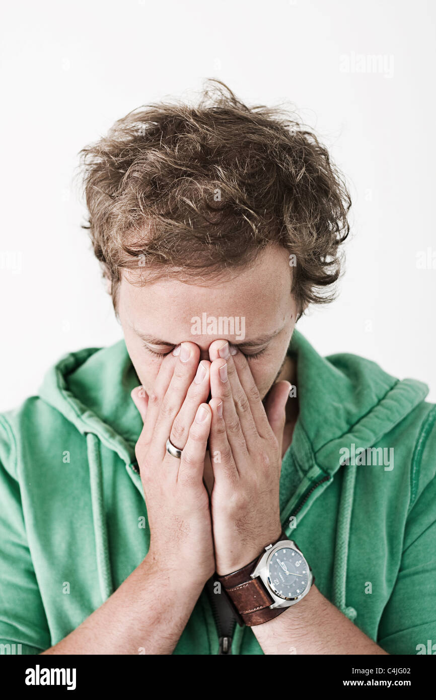 man holding his face Stock Photo - Alamy