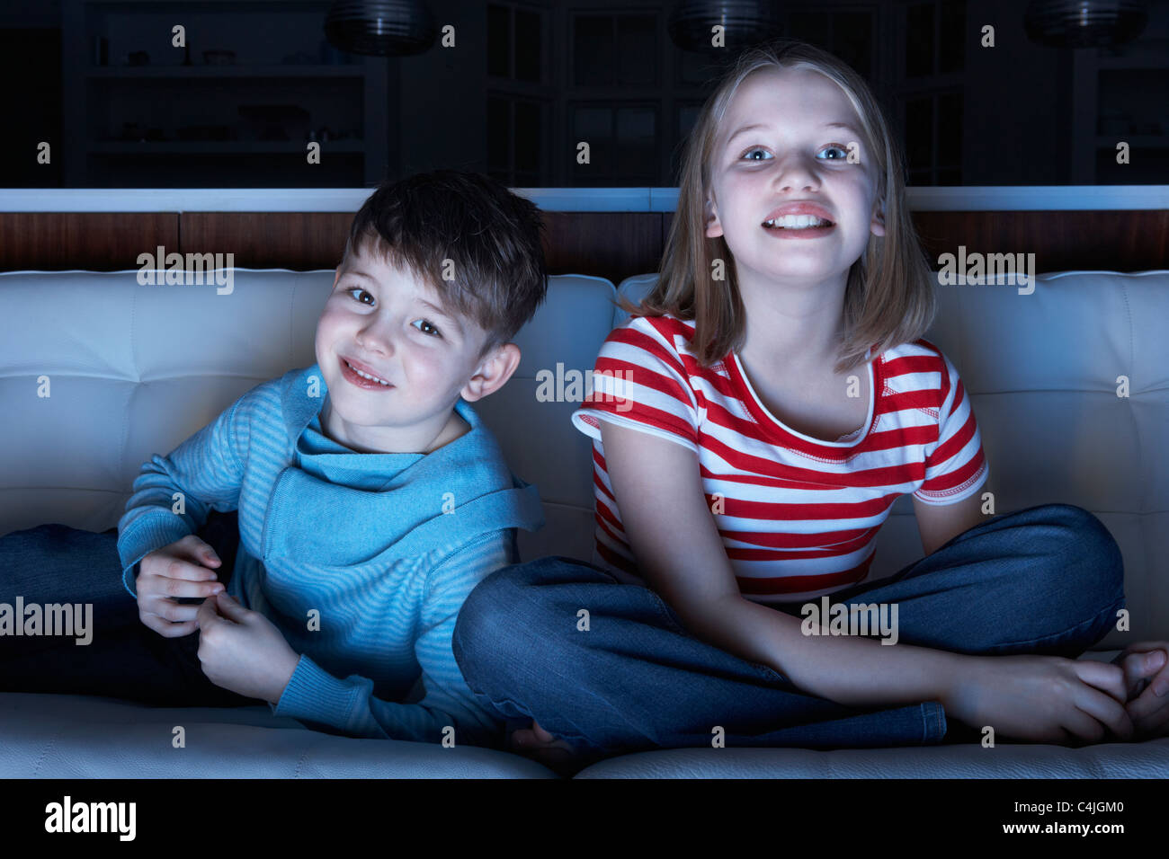 Children Watching TV Together Sitting On Sofa Stock Photo - Alamy