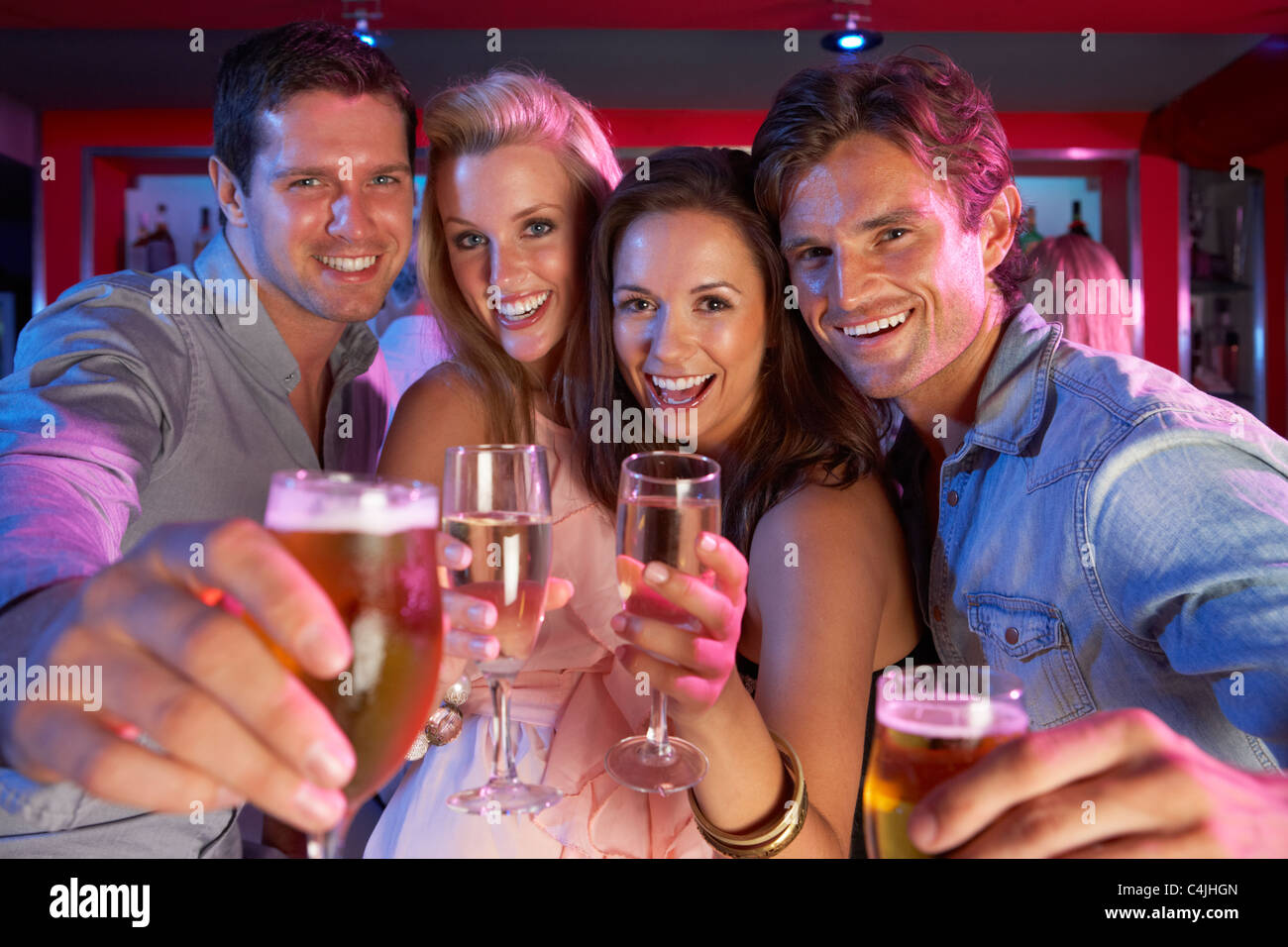Group Of Young People Having Fun In Busy Bar Stock Photo - Alamy