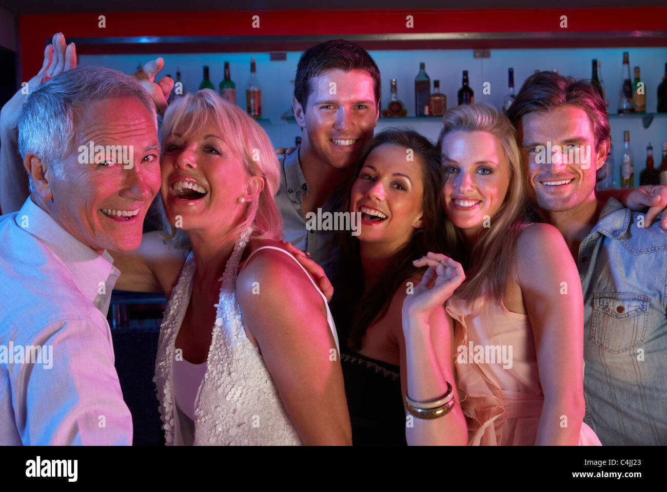 Group Of People Having Fun In Busy Bar Stock Photo - Alamy