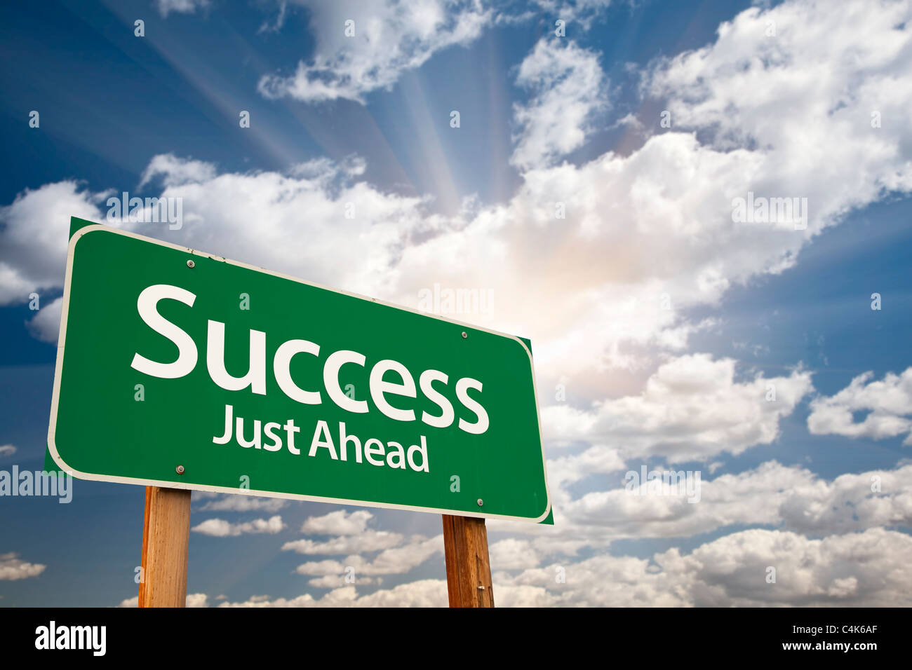 Success Green Road Sign Against Clouds and Sunburst Stock Photo - Alamy
