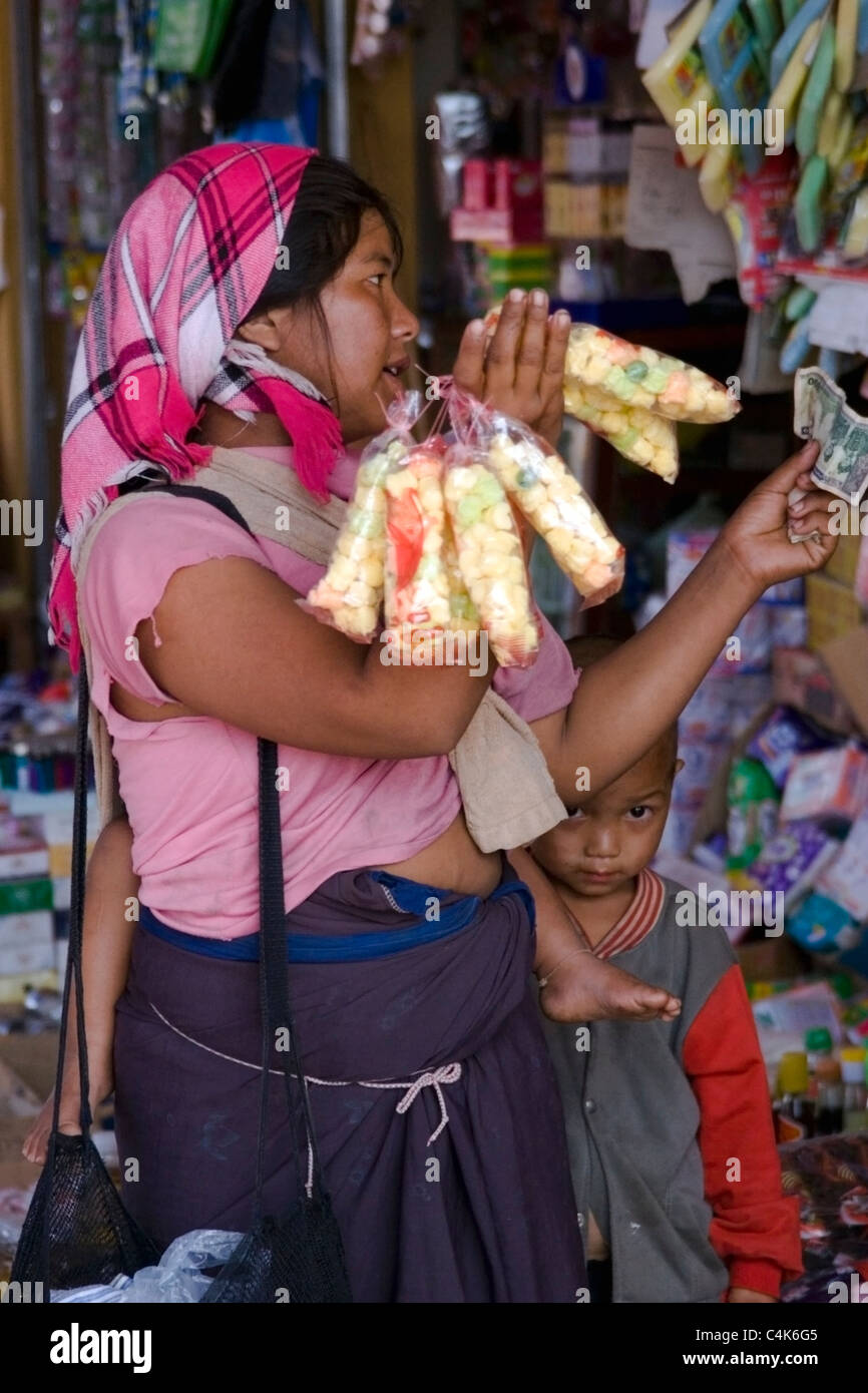 An ethnic hill tribe woman living in poverty is shopping at a food ...