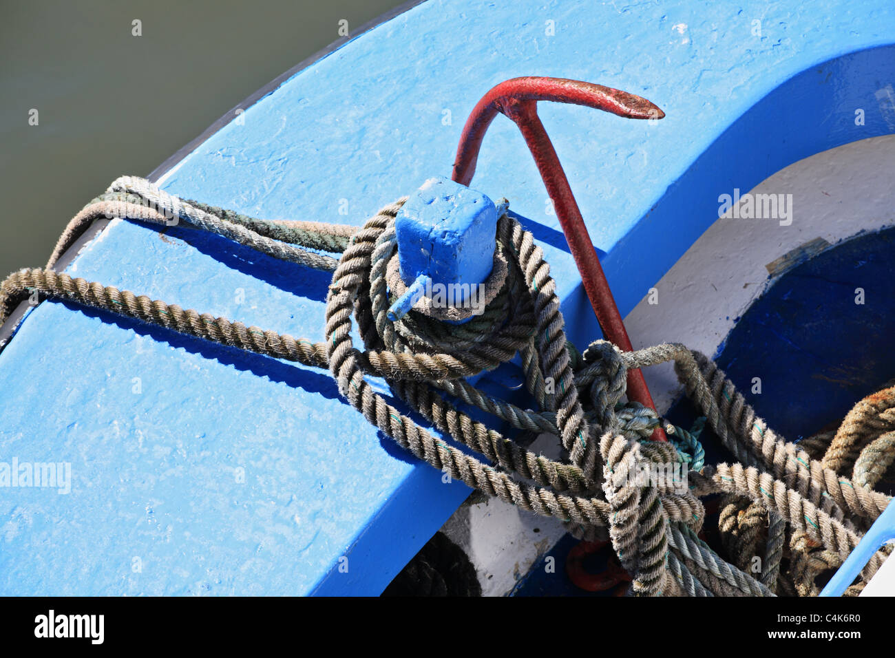 An anchor and a coil of rope on a fishing boat within Craster harbour ...