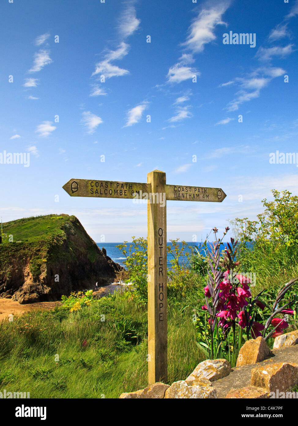 A sign post along the South Devon Coast Path showing distance between ...
