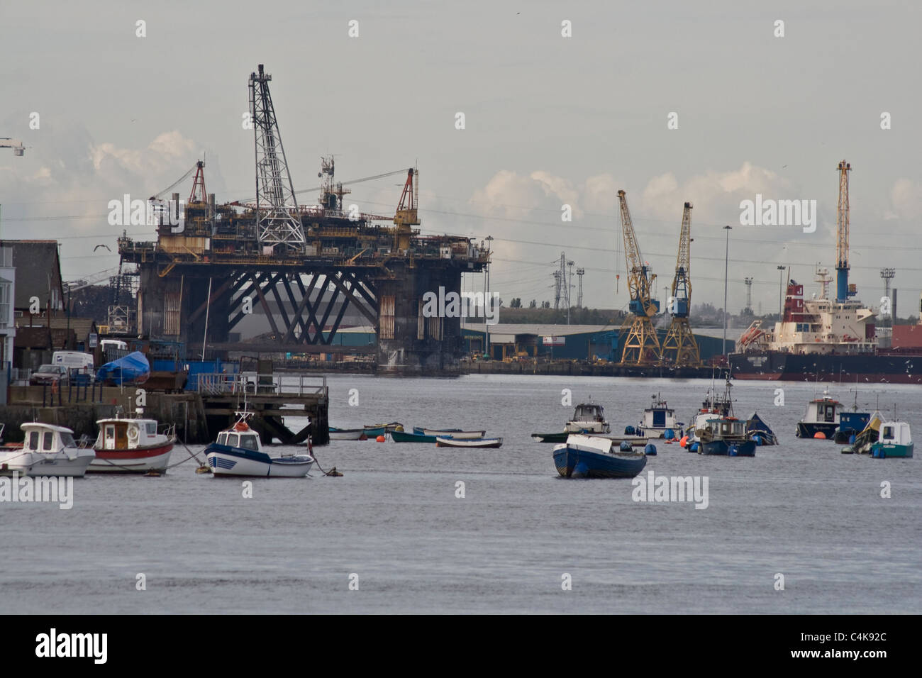 Boats on the River Tyne at port of Tyne with cranes in the background ...
