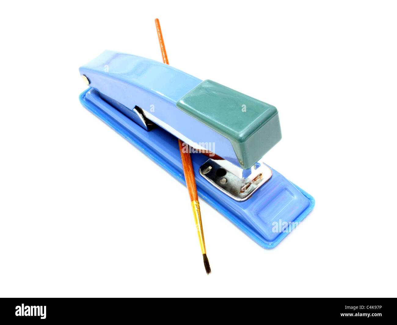 Stapler of dark blue color and brush for paints on a white background ...