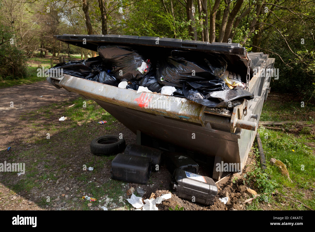 over full rubbish skip in countryside location Stock Photo - Alamy