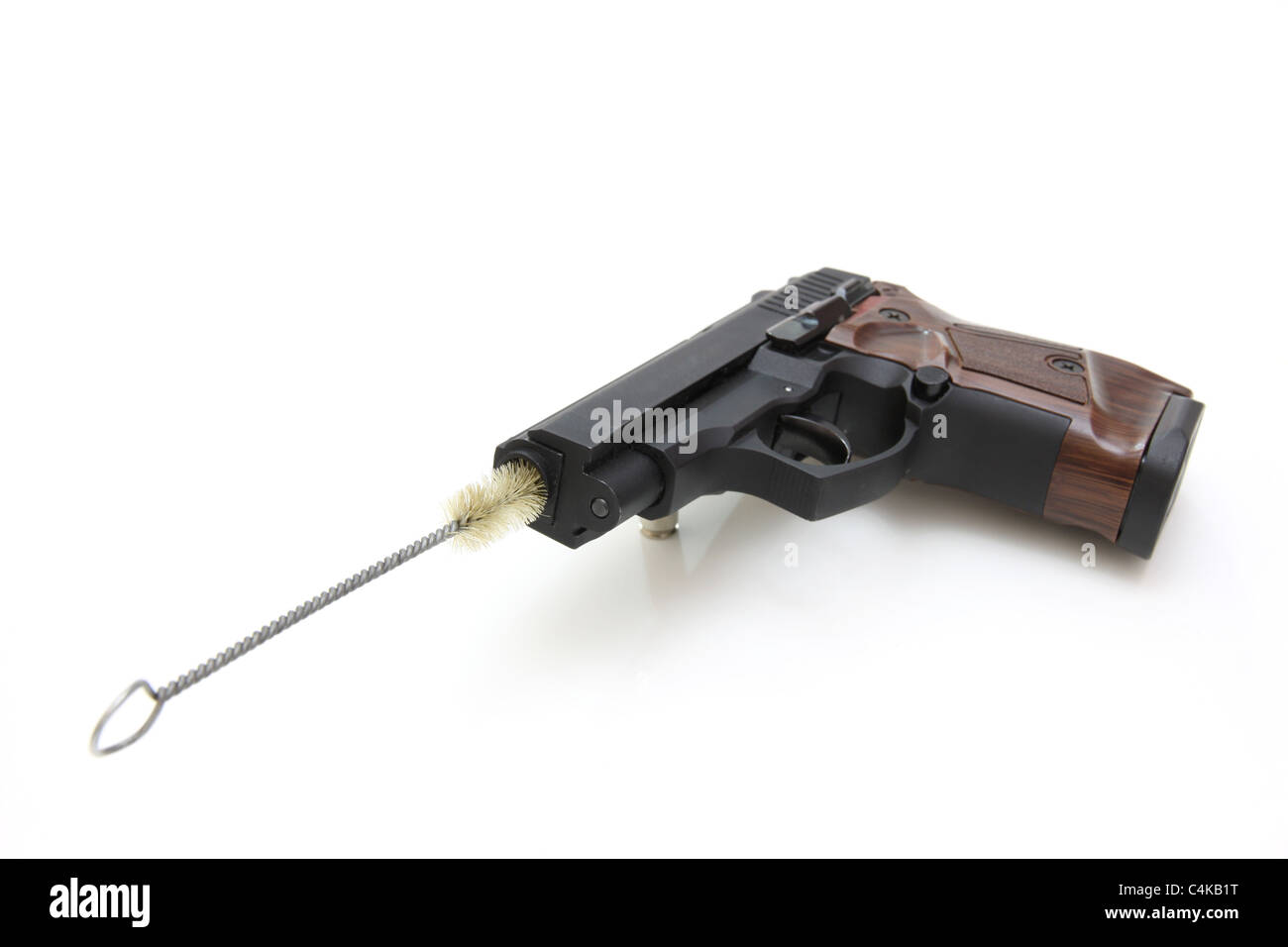 The close up of a pistol and Ruff for weapon cleaningis isolated on a ...