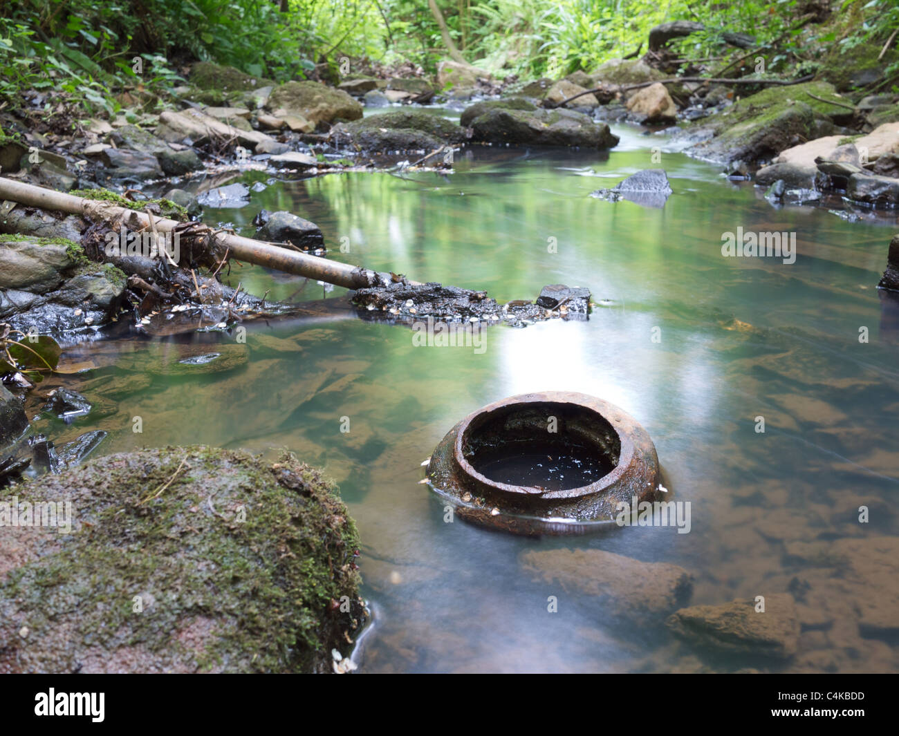 River Stream with rusty iron work and pipes Stock Photo - Alamy