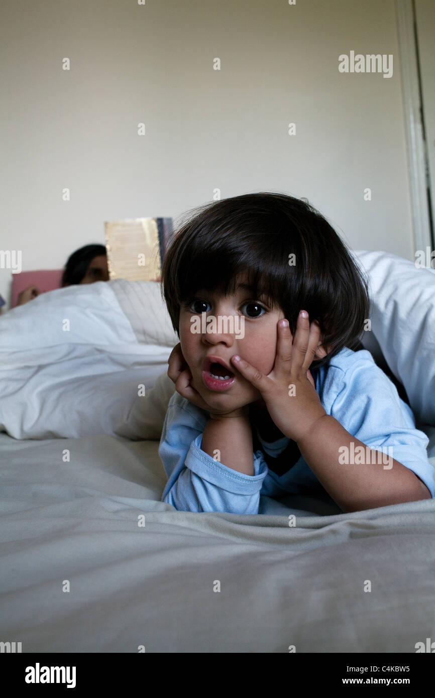 toddler is gasping in excitement or in awe whilst mother is in bed ...