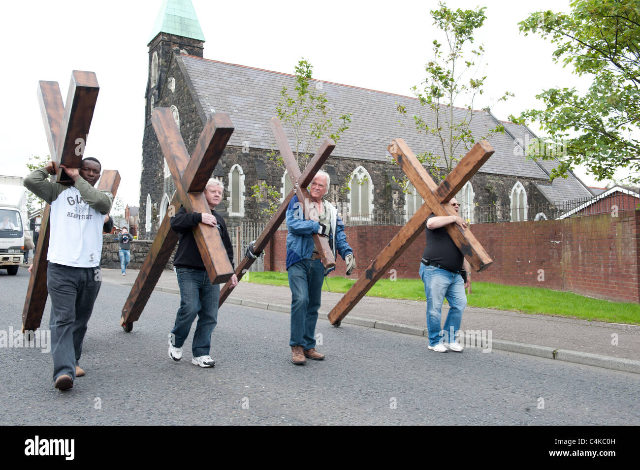 Marchers led by Arthur Blessitt carrying large wooden crosses ...