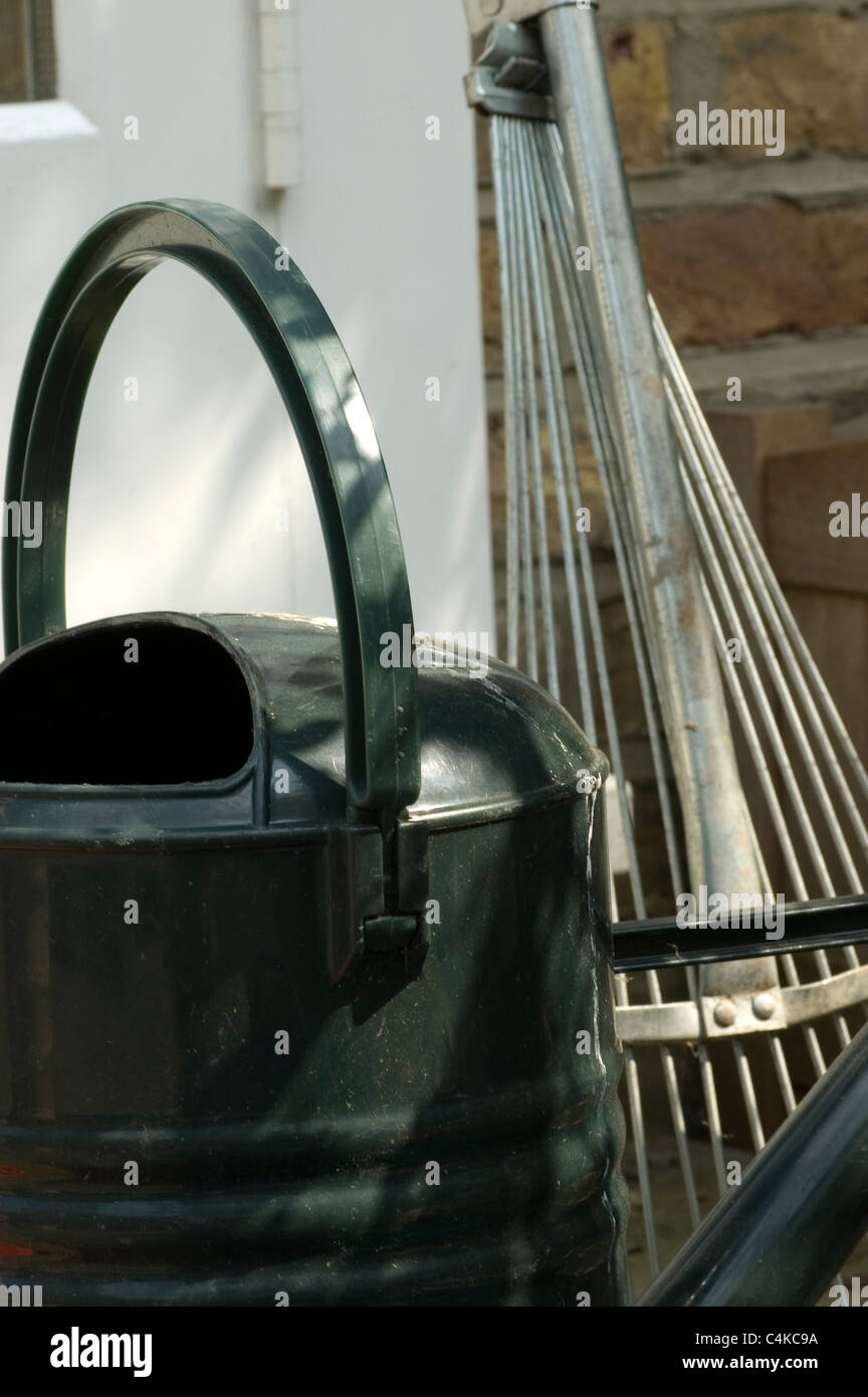Garden Tools - Watering Can and Rake Stock Photo - Alamy