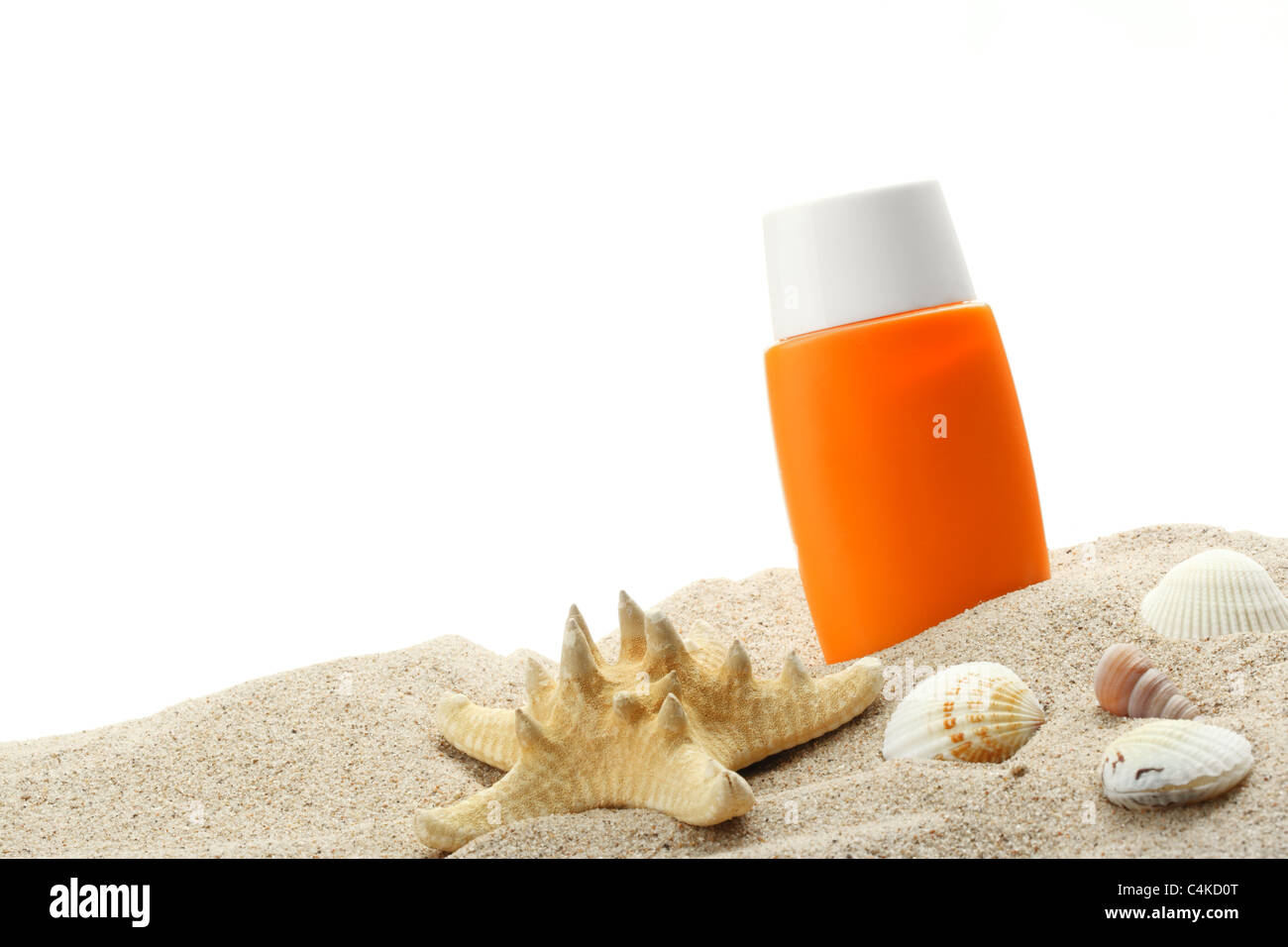 Bottle of sunblock with shells on sand Stock Photo - Alamy
