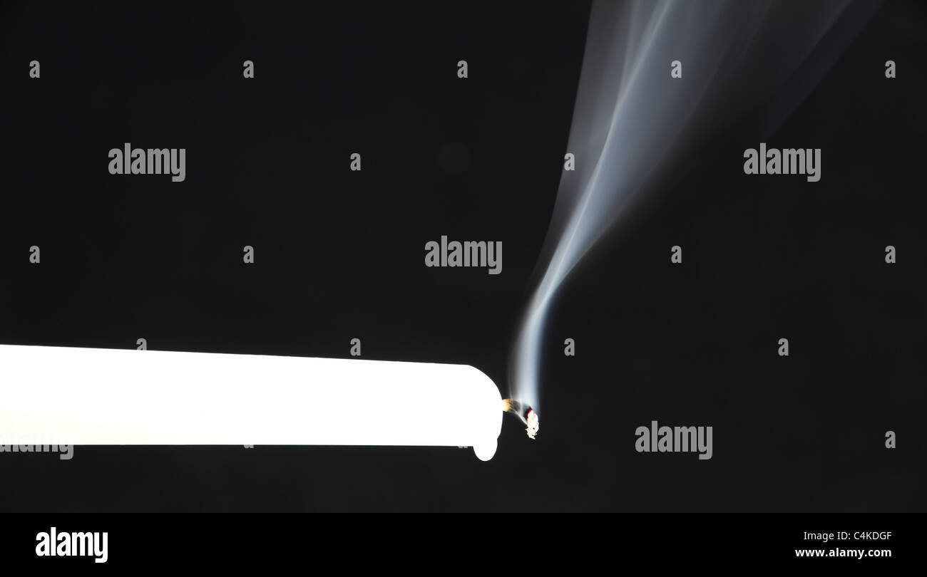 horizontal candle with smoke on a black background Stock Photo - Alamy