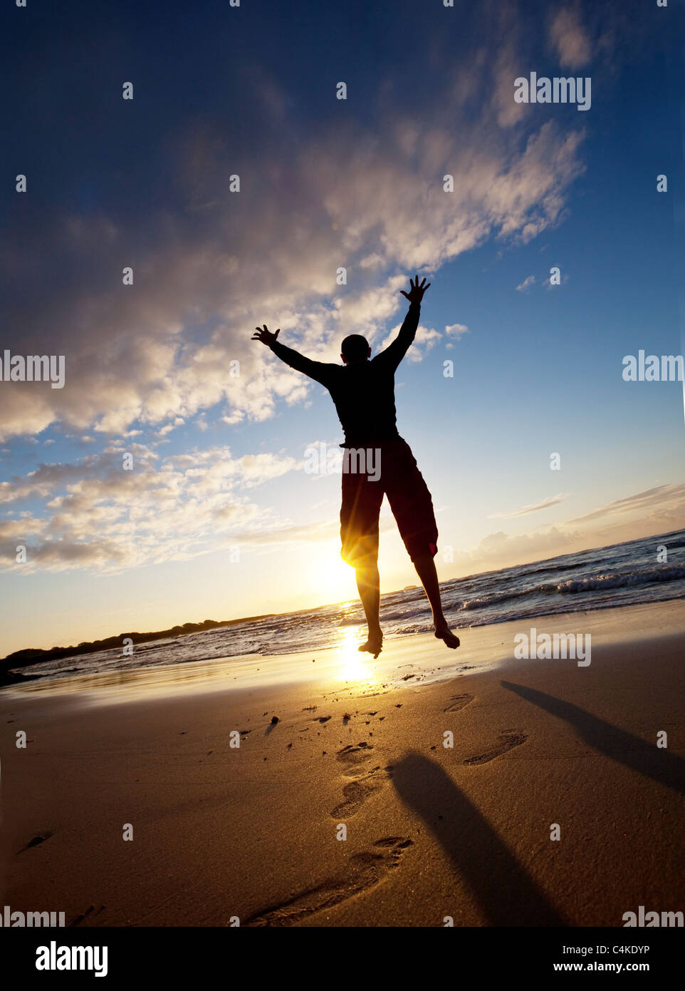 Jumping boy on beach Stock Photo - Alamy