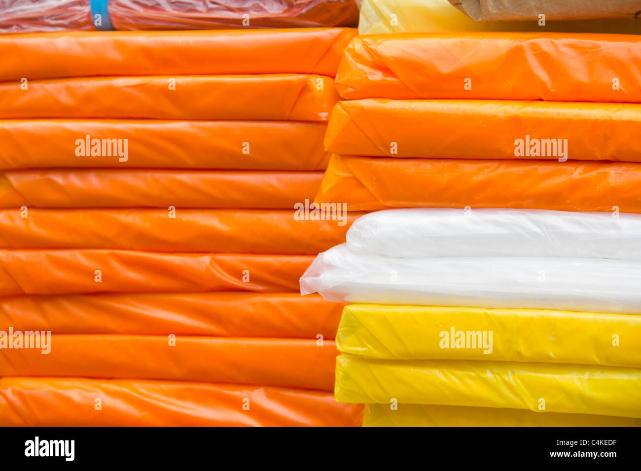 Stacks of bright-colored plastic bags at a shop Stock Photo - Alamy