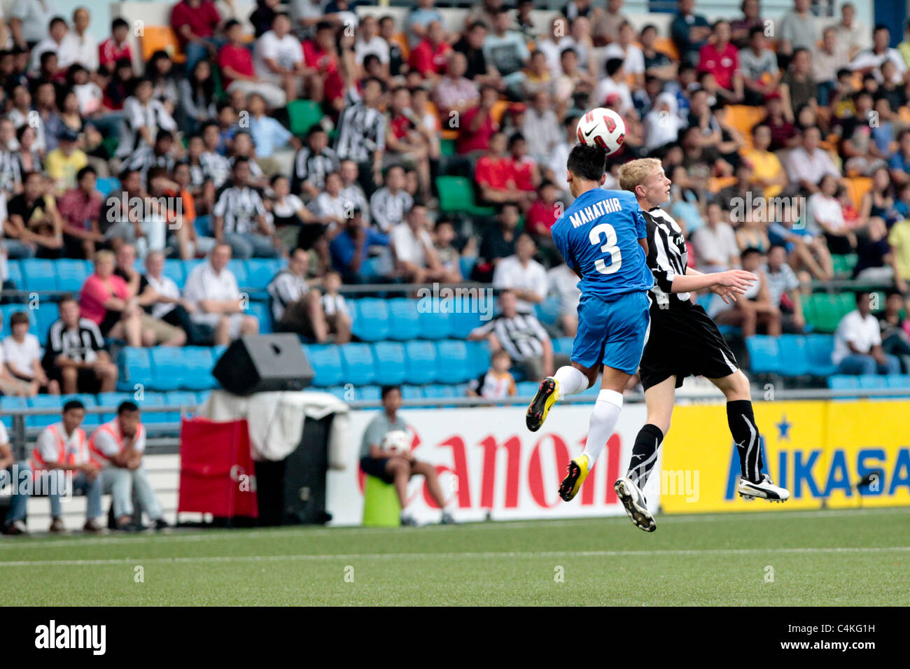 Mahathir Azeman of Singapore U15(blue) and Greg Olley goes up for the ...