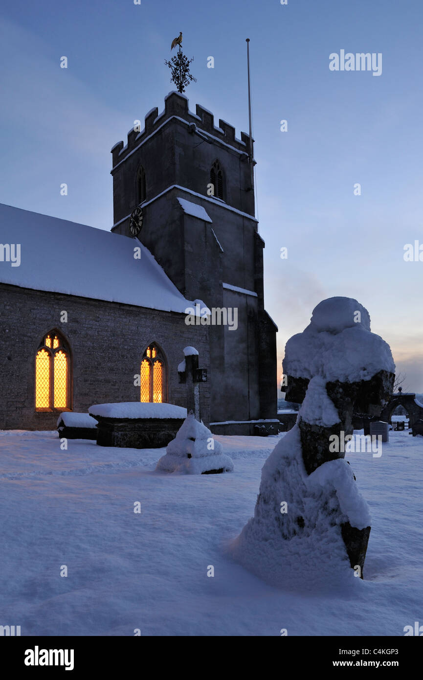 St Dunstan's church in Baltonsborough, Somerset, at twilight on a snowy ...