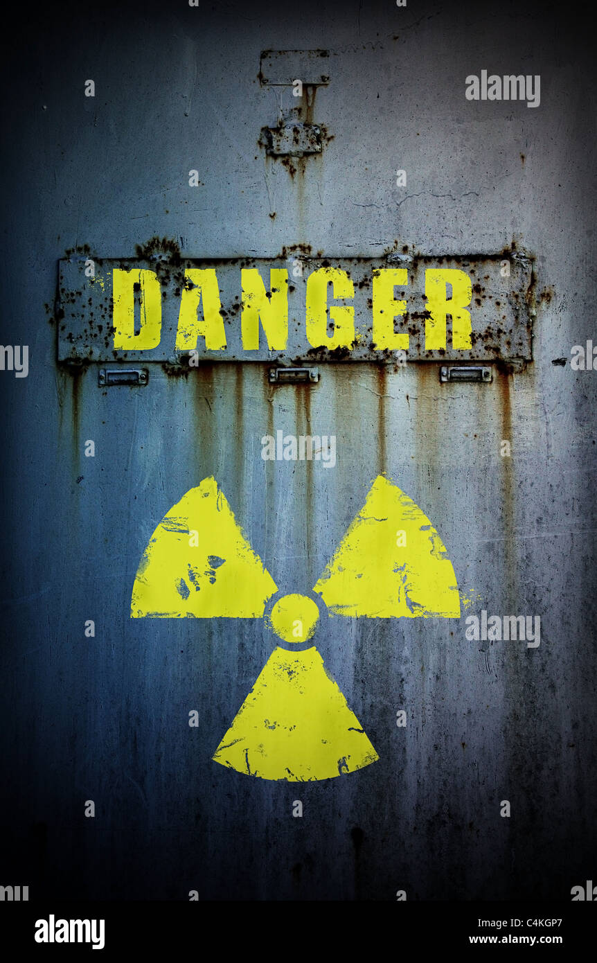 Part of old rusty door with radiation sign and "danger" word. Radiation ...