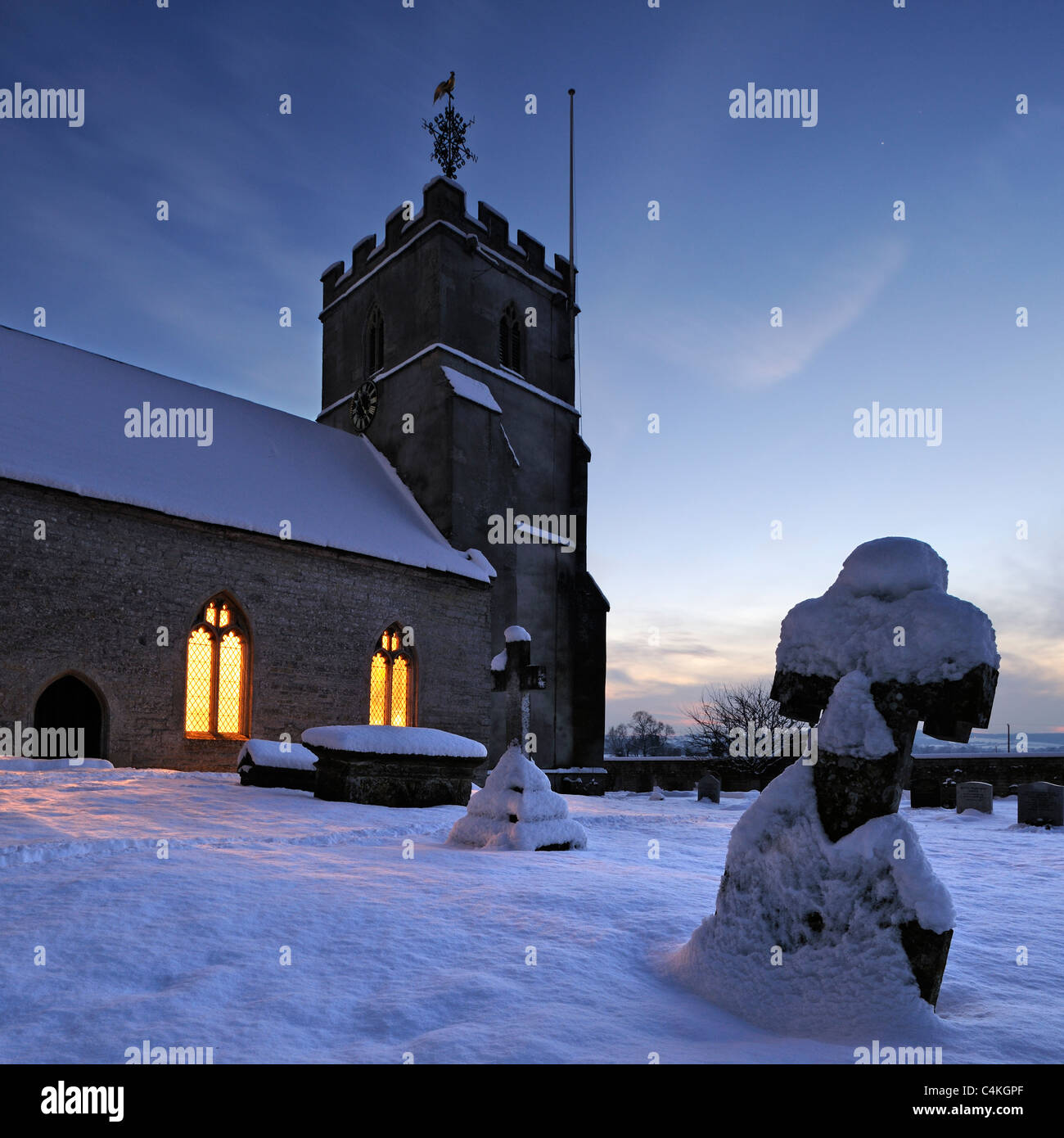 St Dunstan's church in Baltonsborough, Somerset, at twilight on a snowy ...