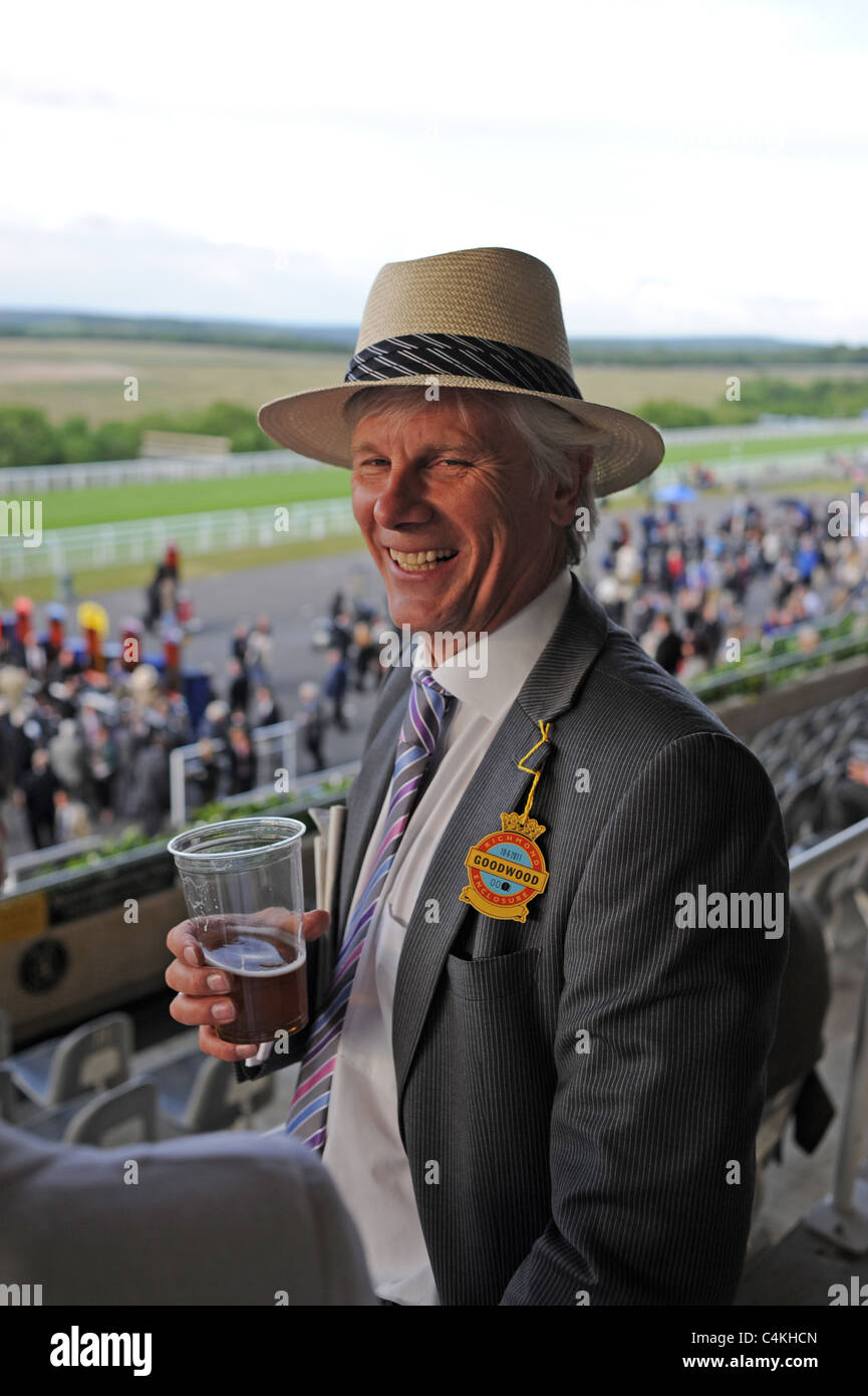 Racegoers at a Goodwood evening meeting in June reading the Racing Post ...