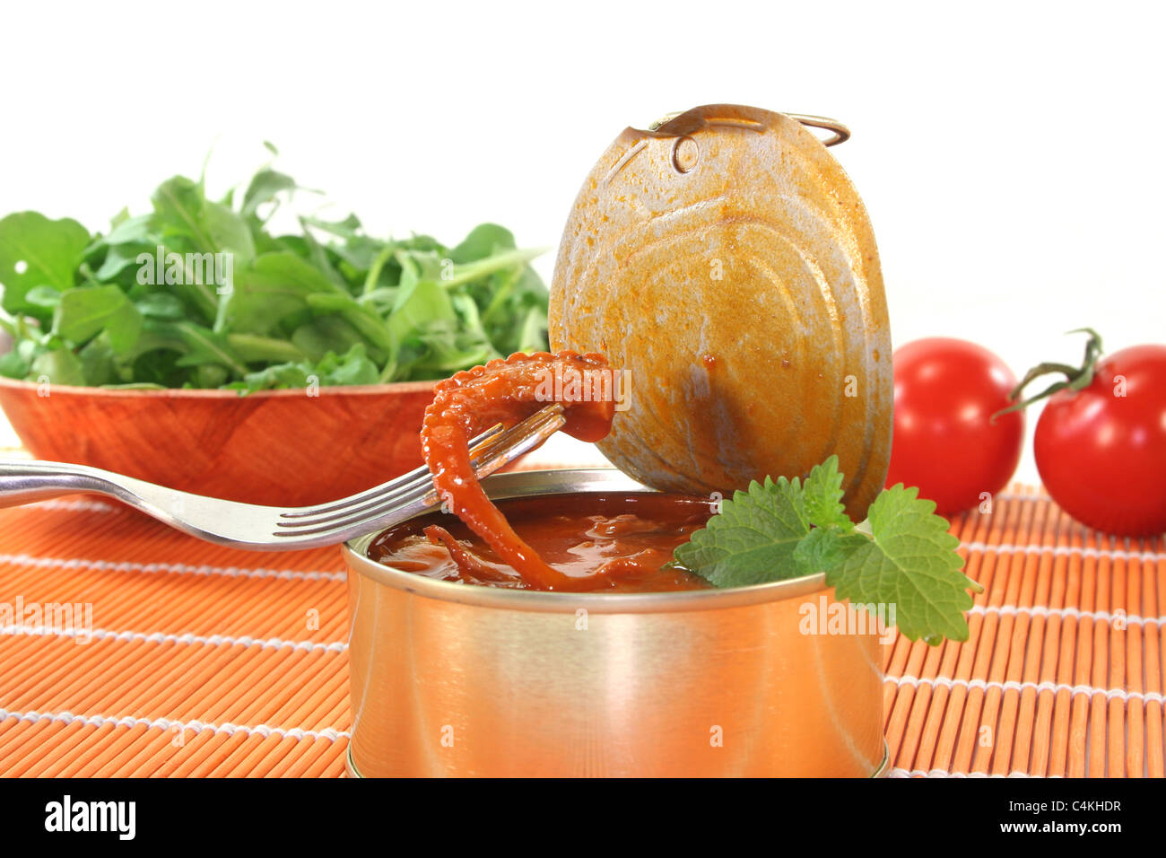 Musky octopus salad on a fork on white background Stock Photo - Alamy