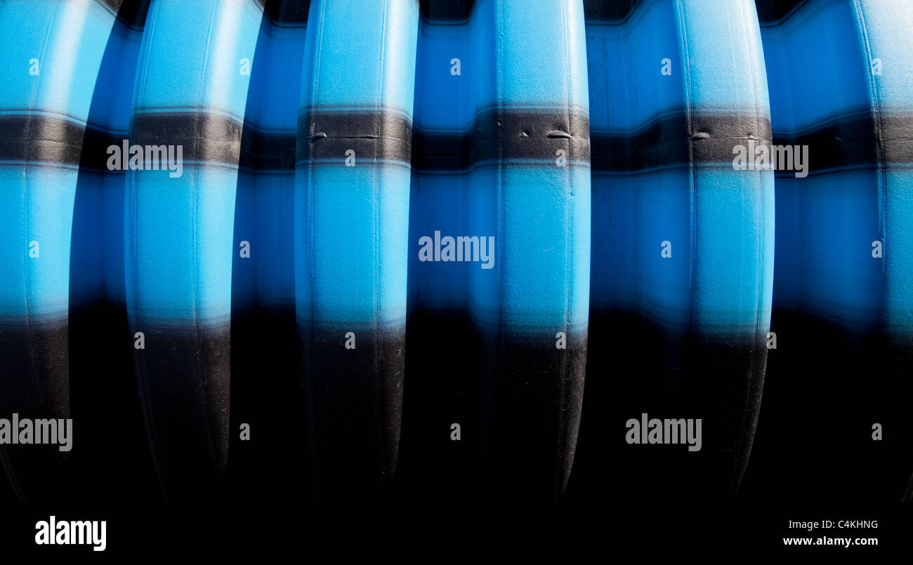 Blue and black stripes on grooved water pipe surface Stock Photo - Alamy