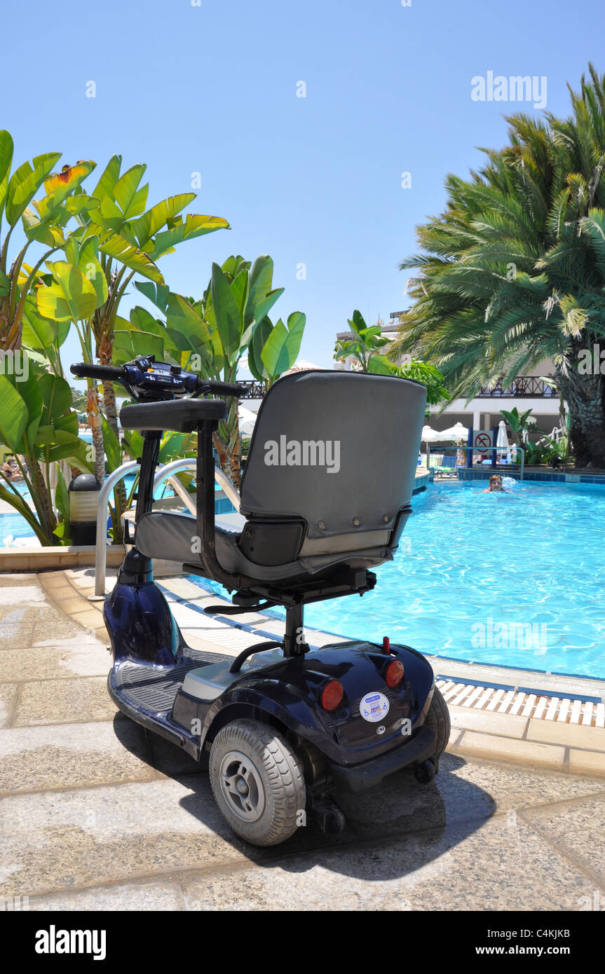 Mobility scooter by swimming pool Cyprus Stock Photo - Alamy