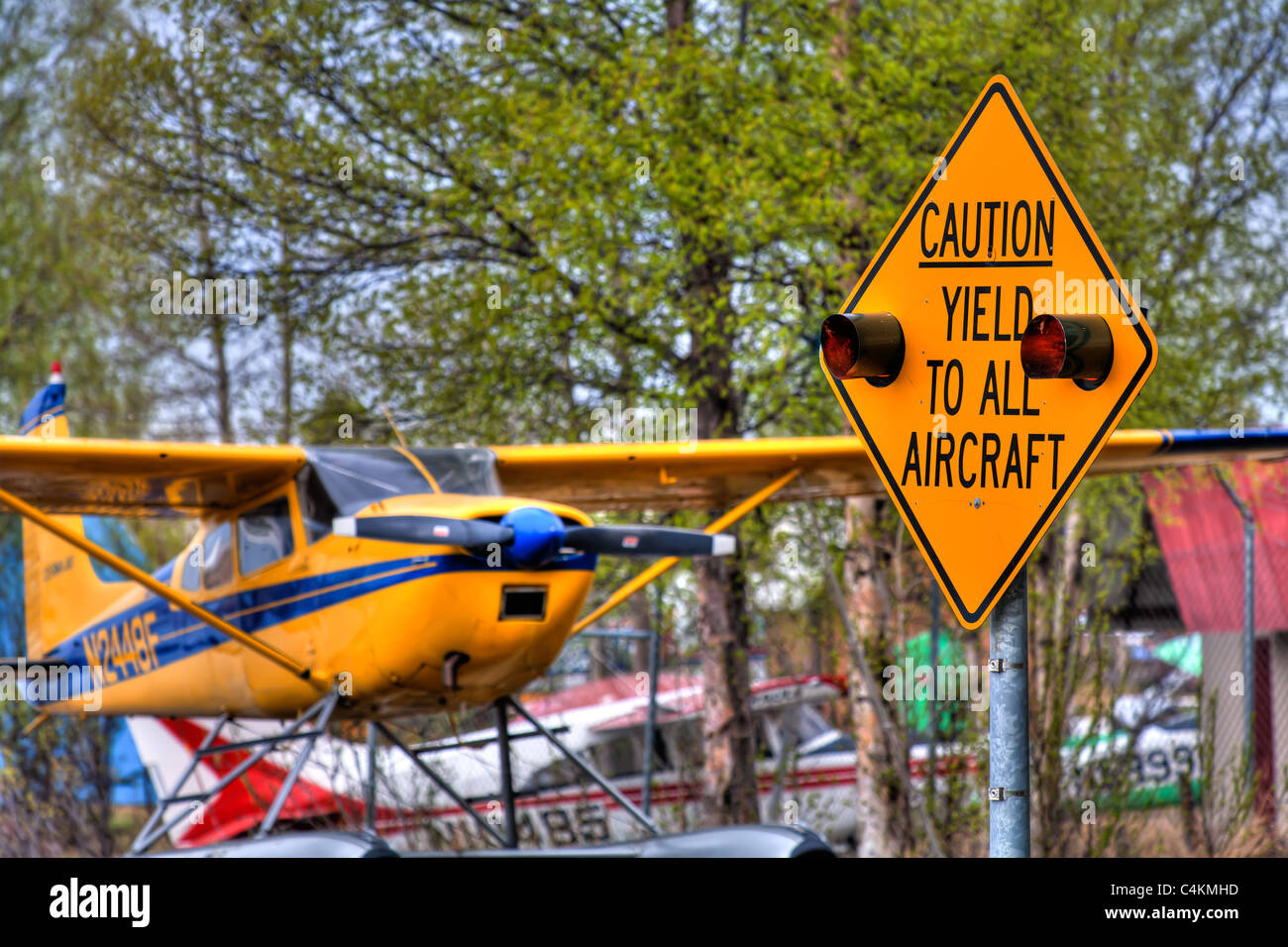 Float Plane and "Caution Yield To All Aircraft" sign at Lake Hood in ...