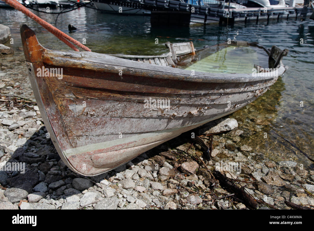 An abandoned boat, half sunk, left moored in the port Stock Photo - Alamy