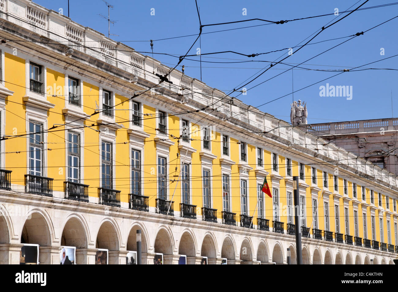 Power lines of the trams and yellow buildings, Terreiro do Paço or ...