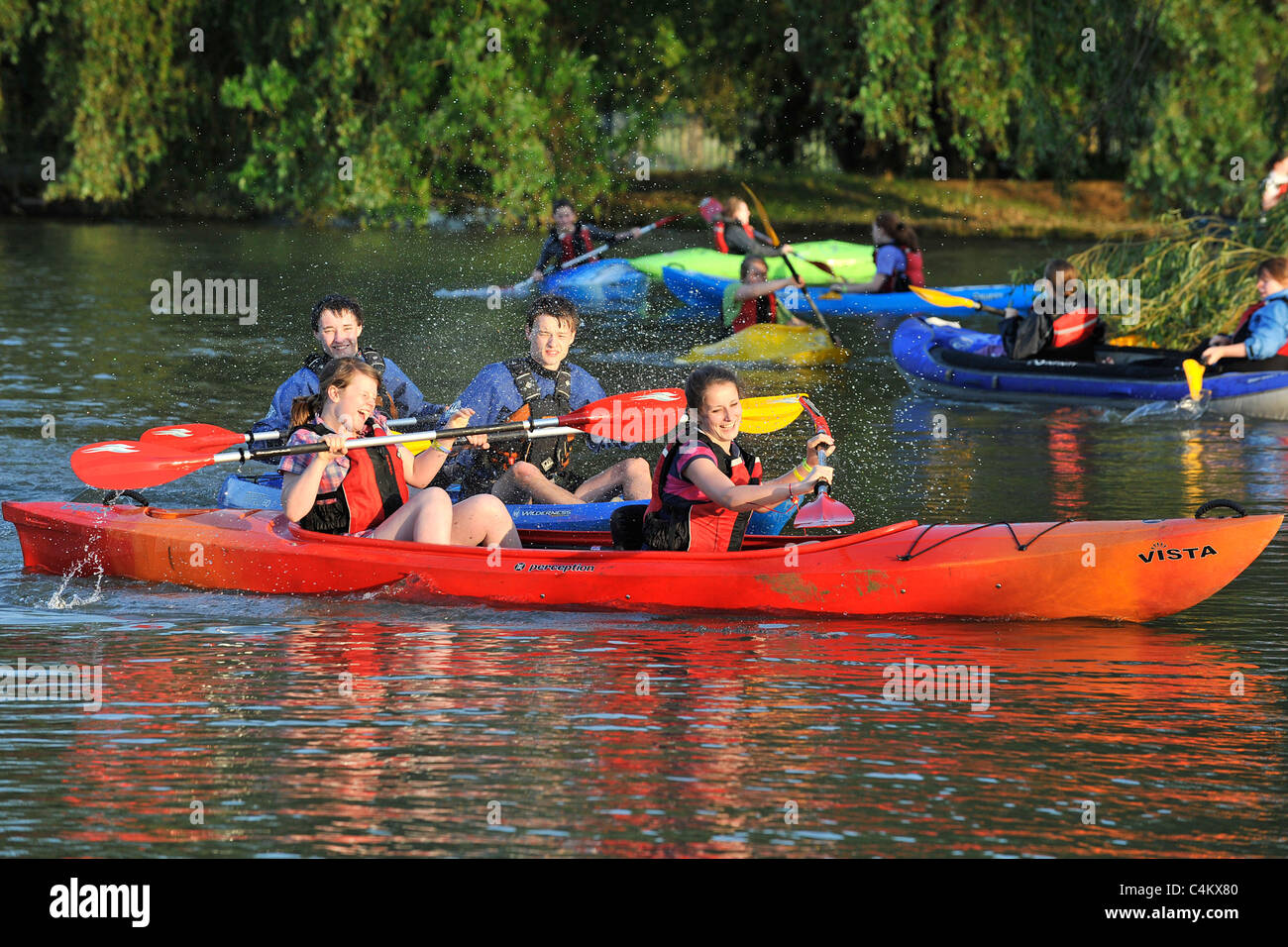 teenagers in canoes on a lake having fun Stock Photo - Alamy