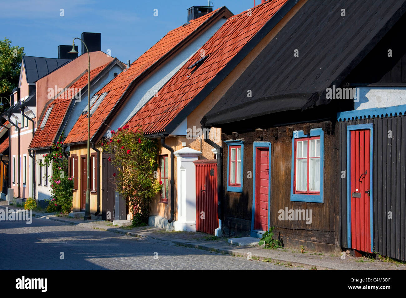 Traditional wooden houses in cobbled street of the Hanseatic town Visby ...