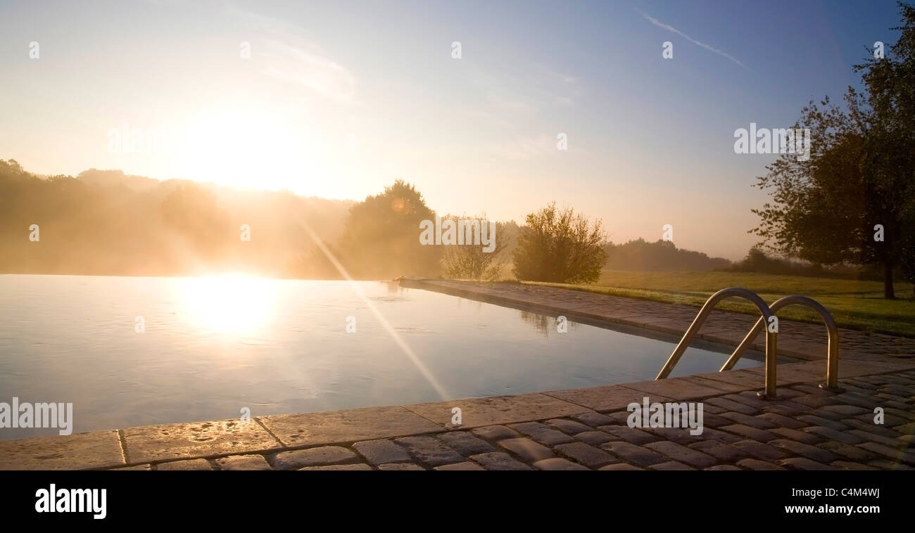 Early morning mist over swimming pool hi-res stock photography and ...