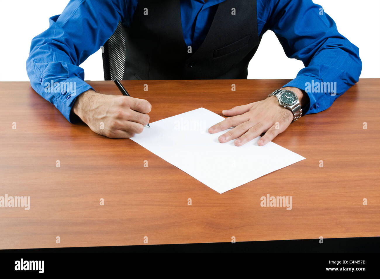 Close up of the body of a professional man sitting with his hands on a ...