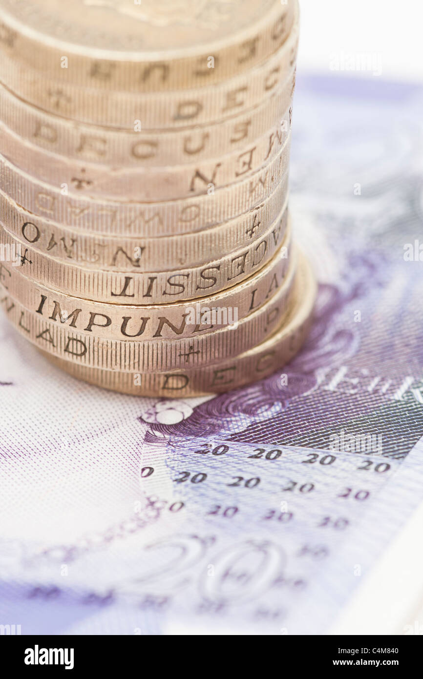 Closeup of Stack / Pile of One Pound Coins on top of Twenty Pound Notes ...