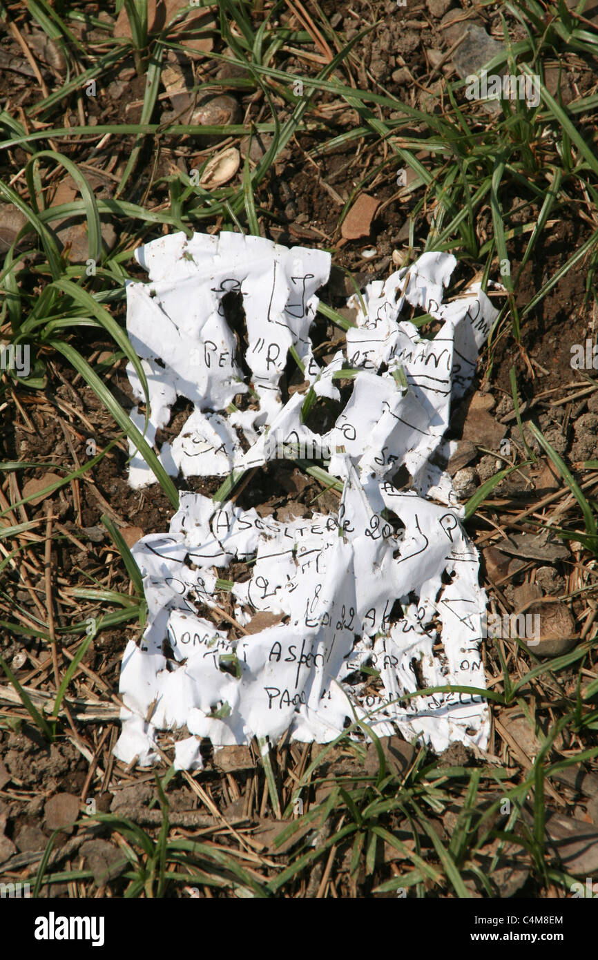 worn decomposing piece of paper note in grass in field Stock Photo - Alamy