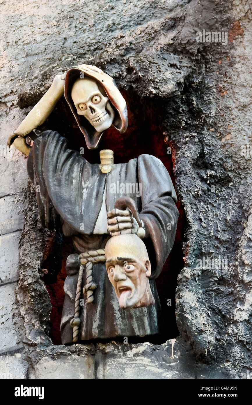 A beheaded monk on a haunted house exchanging heads with a skeleton ...