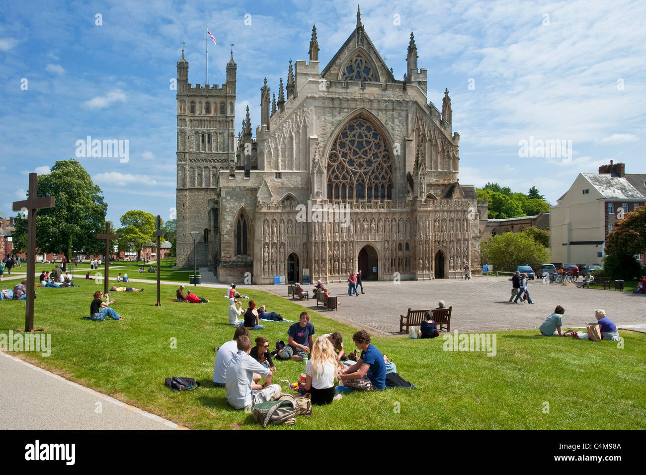 The famous West Window of Exeter Cathedral with students relaxing on ...