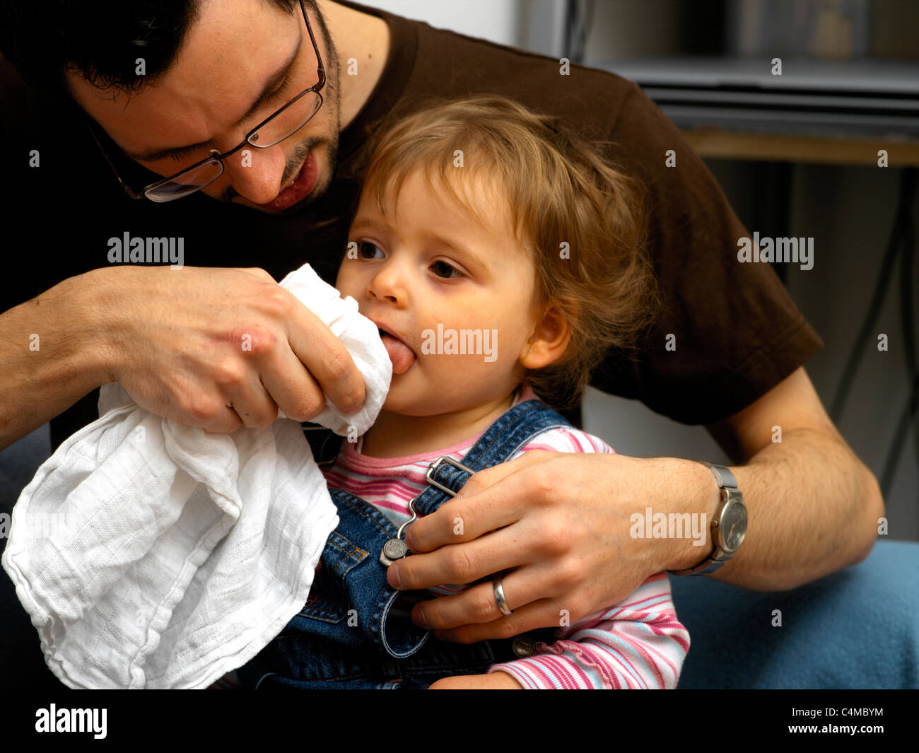Father Wiping Eighteen Month Old Daughters Mouth Stock Photo - Alamy