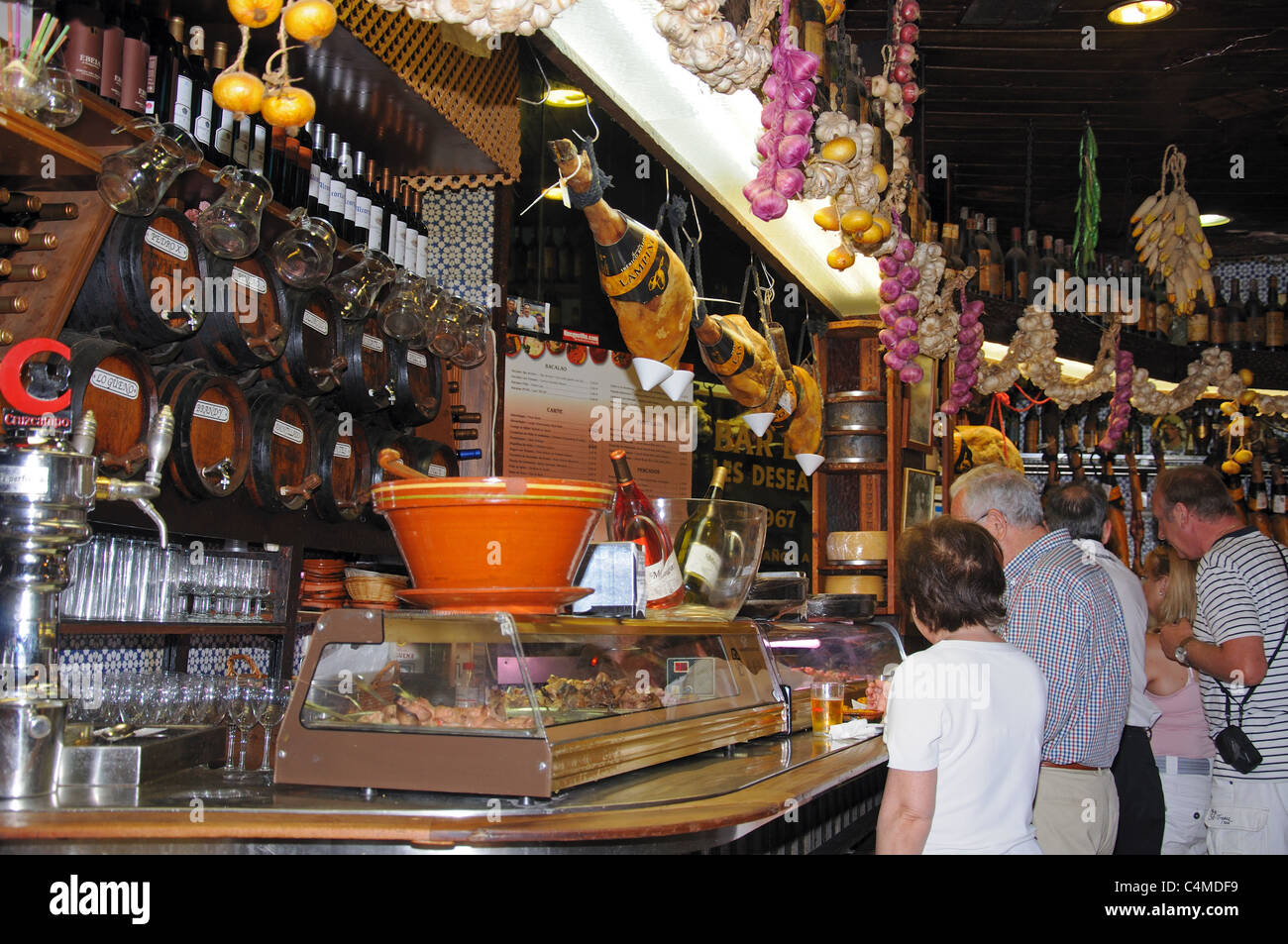 Tourists standing at the counter of a Tapas Bar, Malaga, Costa del Sol ...