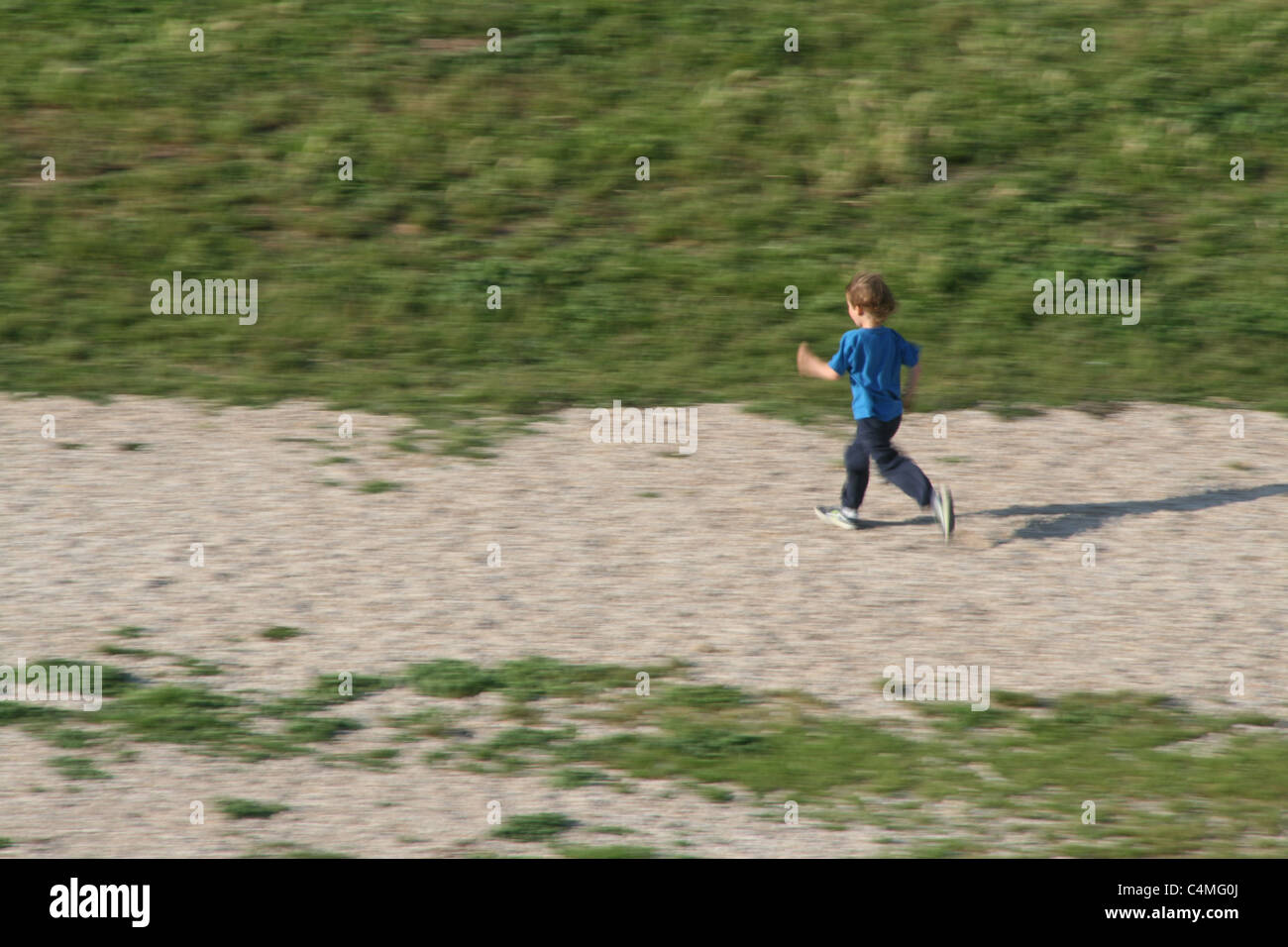 abstract boy running down hill with blue ribbon garland Stock Photo - Alamy