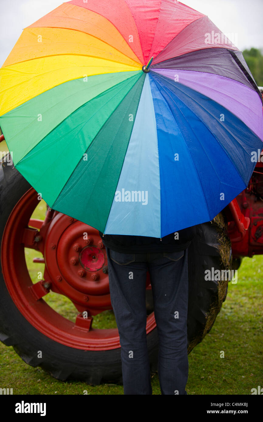 Rainbow Umbrella and Tractor Wheel Stock Photo - Alamy