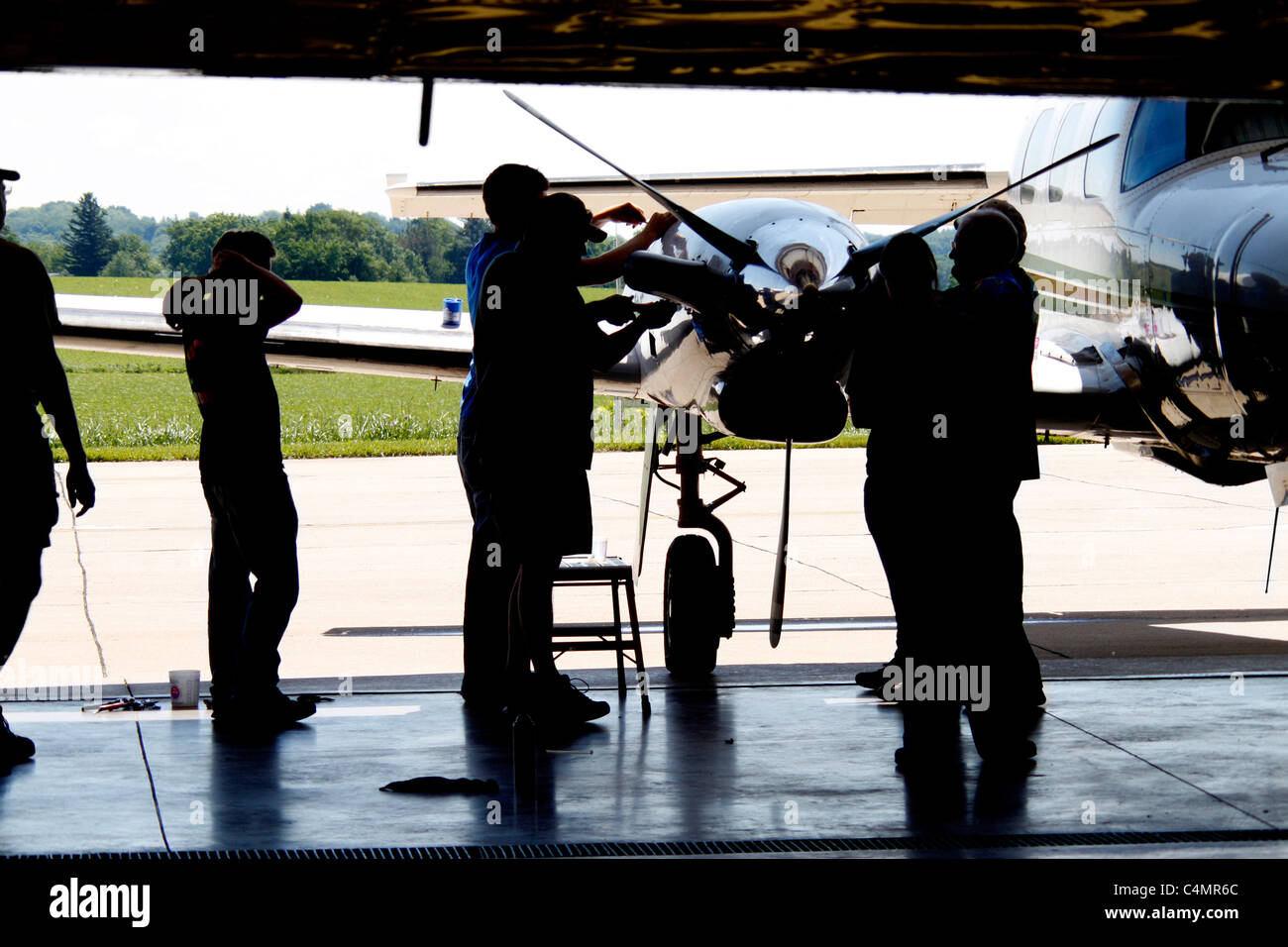 Crew works on turboprop engine Stock Photo - Alamy