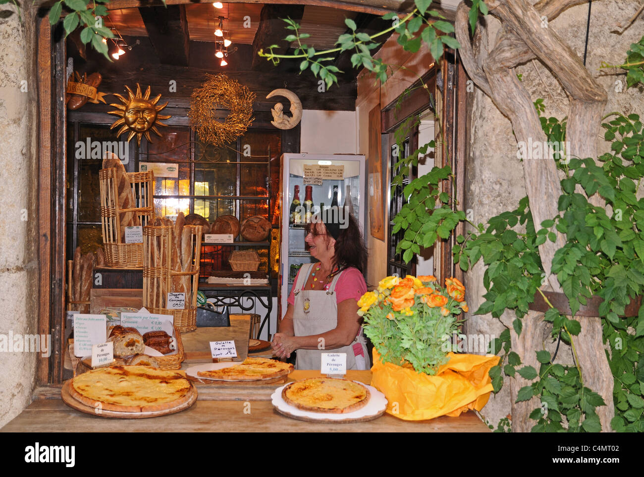 Lady selling bread and galettes from small shop on Rues des Rondes ...