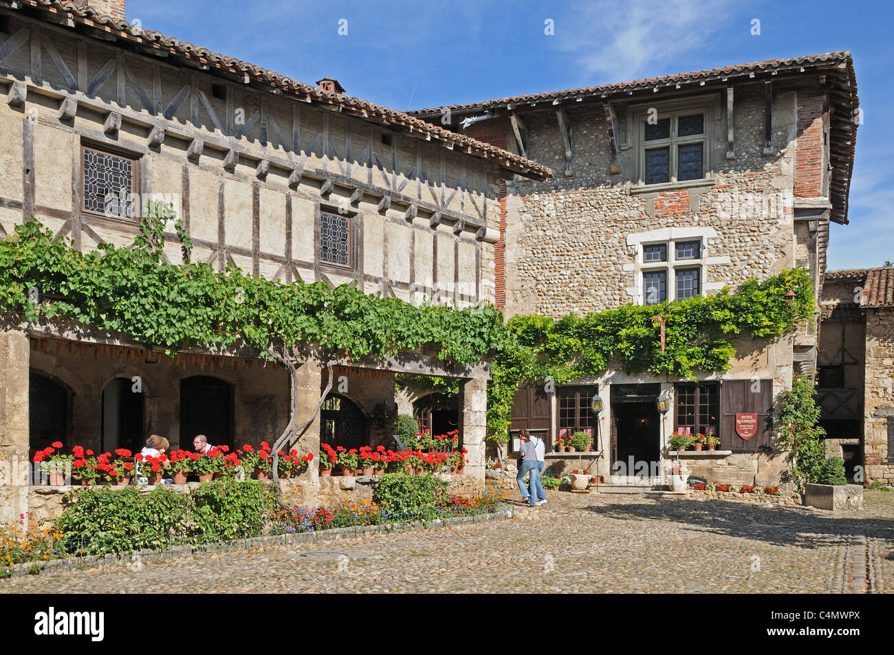 Breakfast verandah Hostellerie de Perouges with red geranium flowers ...